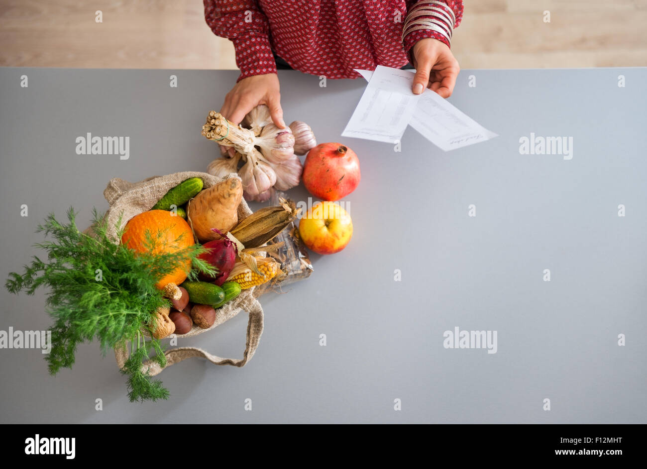 Seen from above, a burlap sac is full of fresh fall fruits and ...