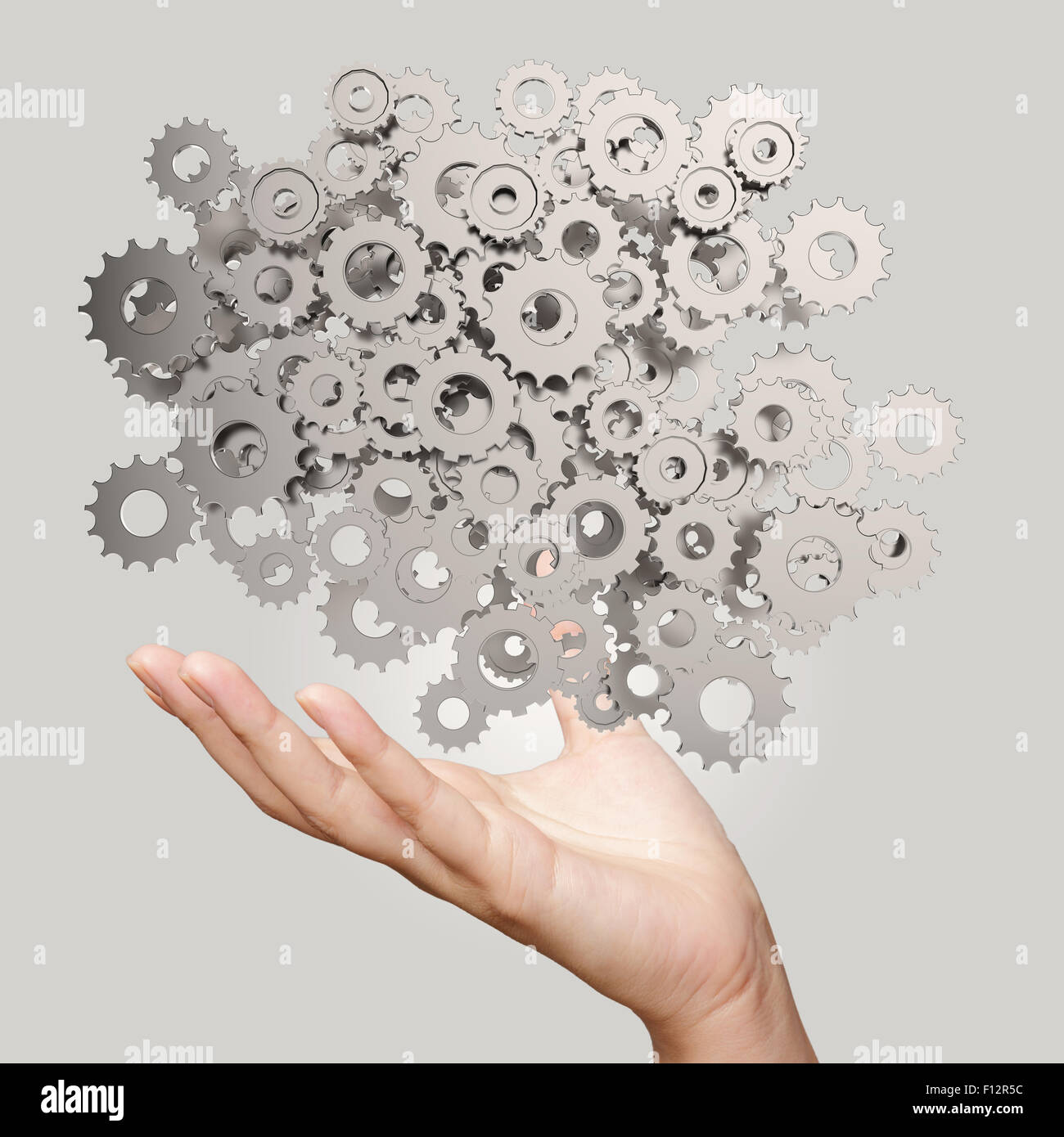 businessman hand showing gears cogs to success concept Stock Photo - Alamy