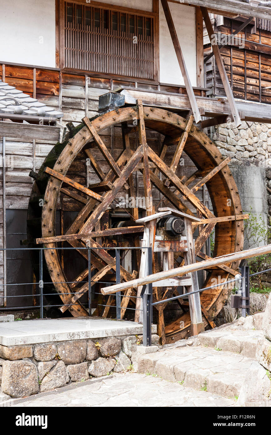 Edo period traditional water wheel on the side of a wood and plaster ...