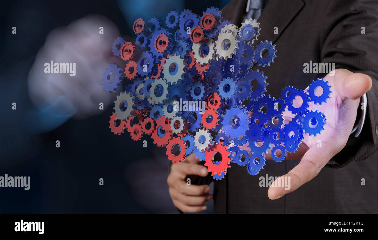 businessman hand showing gears cogs to success concept Stock Photo - Alamy