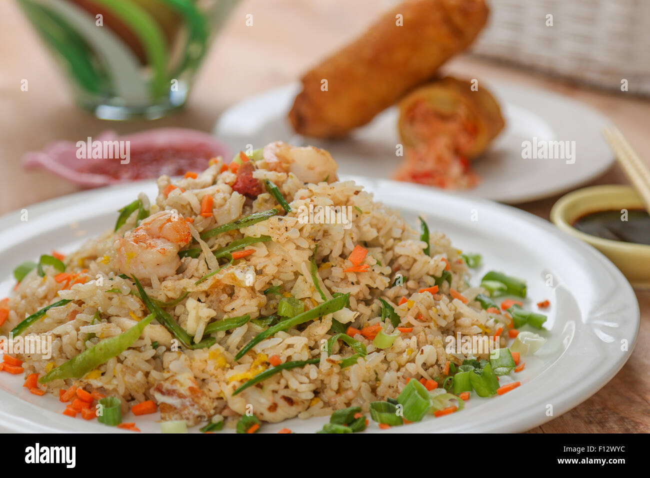 Chinese food fried rice and egg rolls on wood table Stock Photo - Alamy