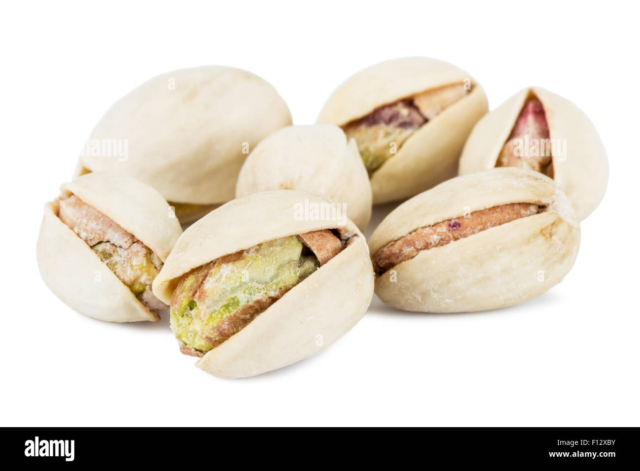 Close-up of a small group of pistachio seeds with shell isolated on ...