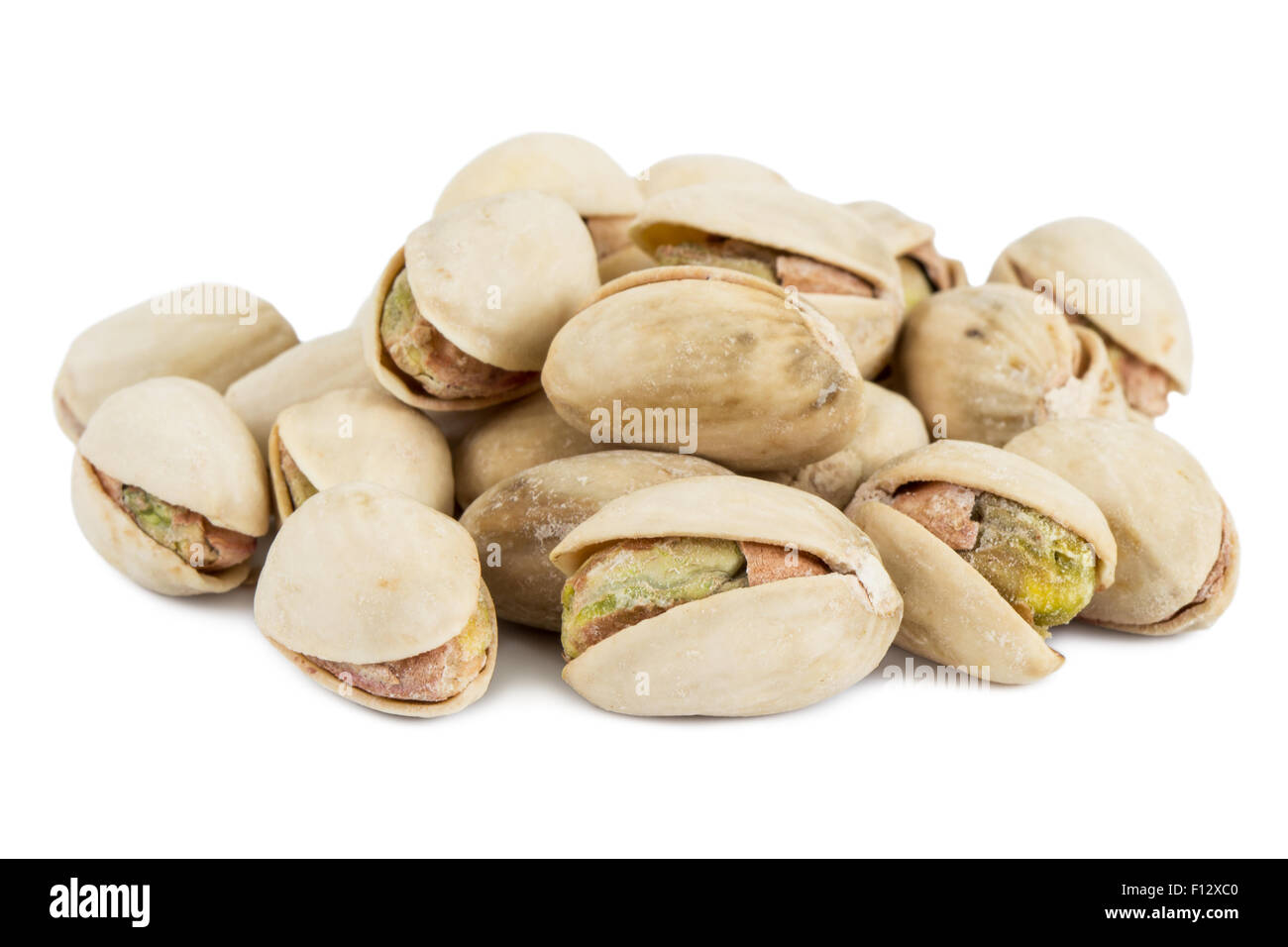Close-up of a heap of pistachio seeds with shell isolated on white ...
