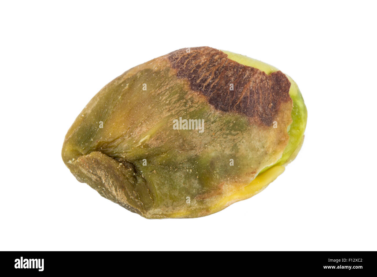 Close-up of a pistachio seed with no shell isolated on white background ...