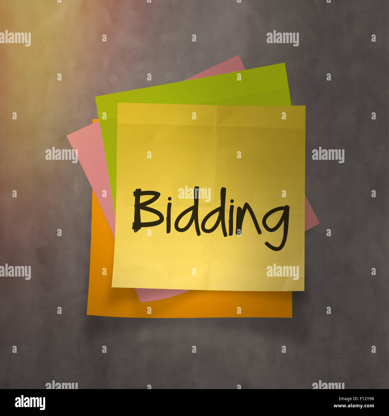 bidding text on sticky note paper on wall texture Stock Photo - Alamy