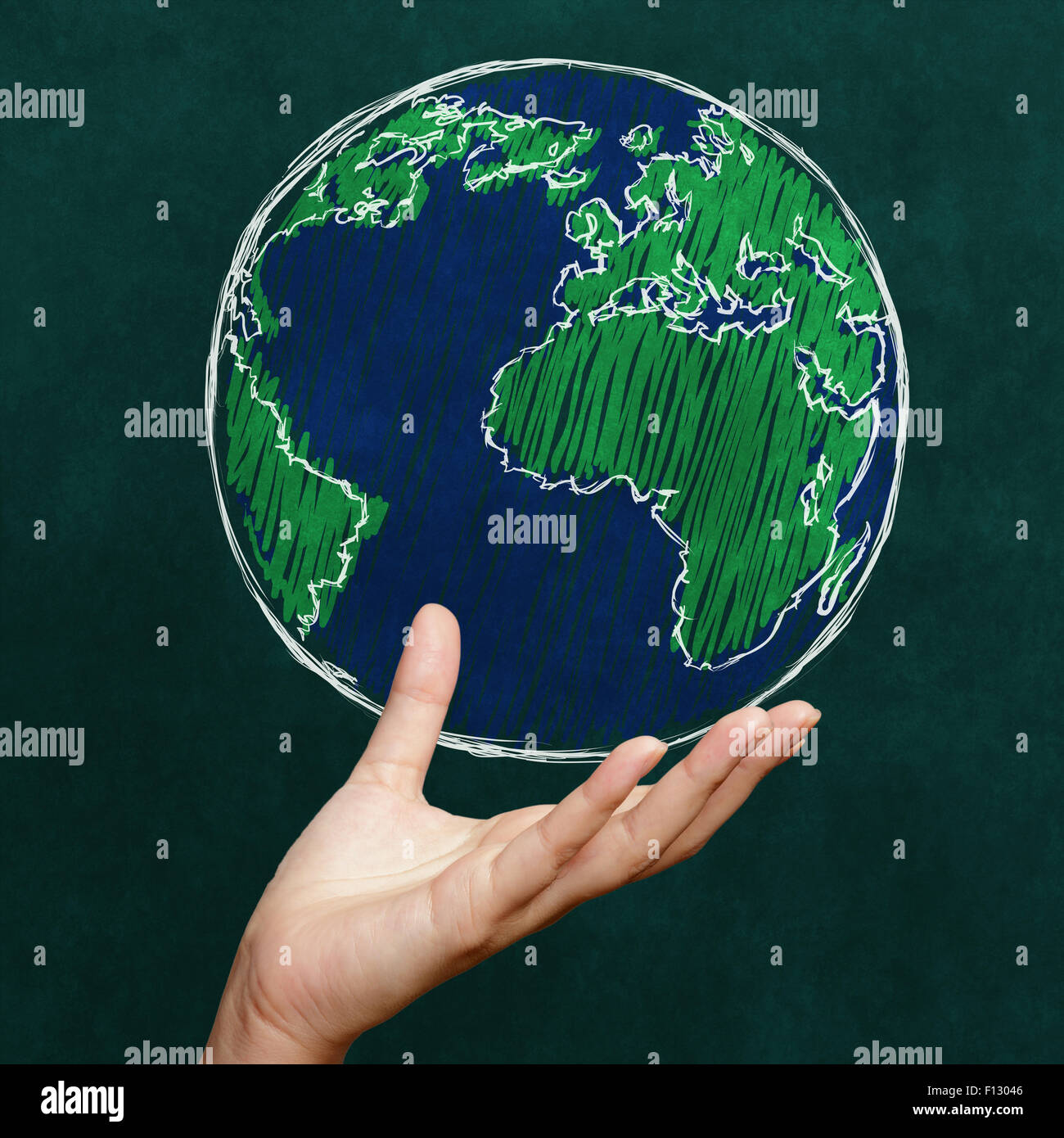 Hand holding world on chalkboard as concept Stock Photo - Alamy