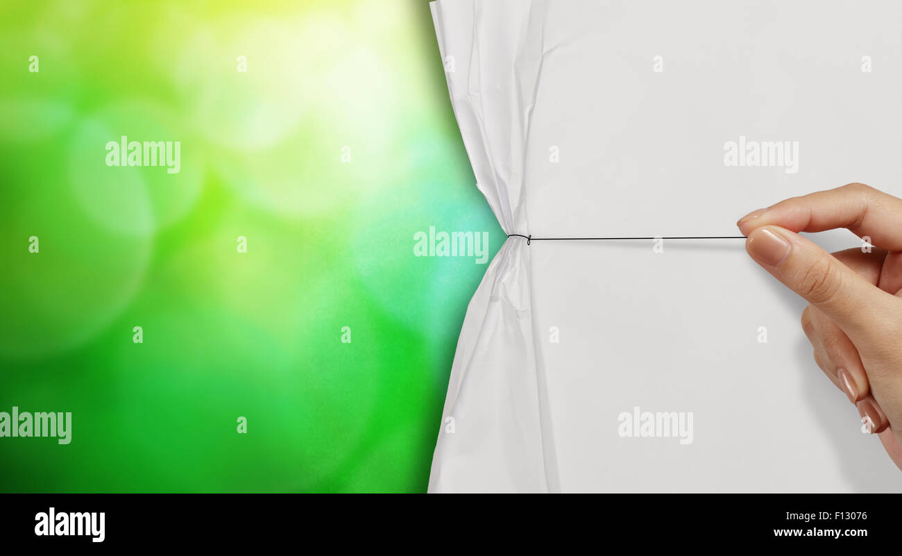 hand open crumpled paper to show green nature background as concept ...