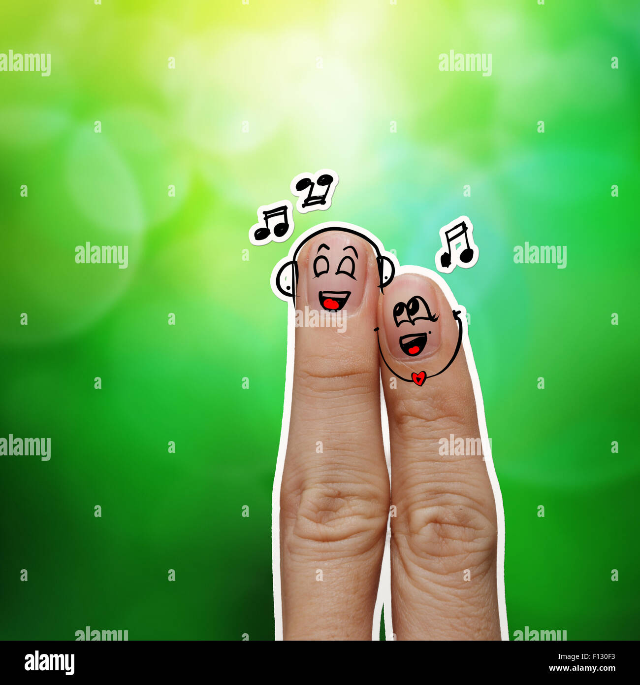 the happy finger couple in love with painted smiley and sing a song on ...