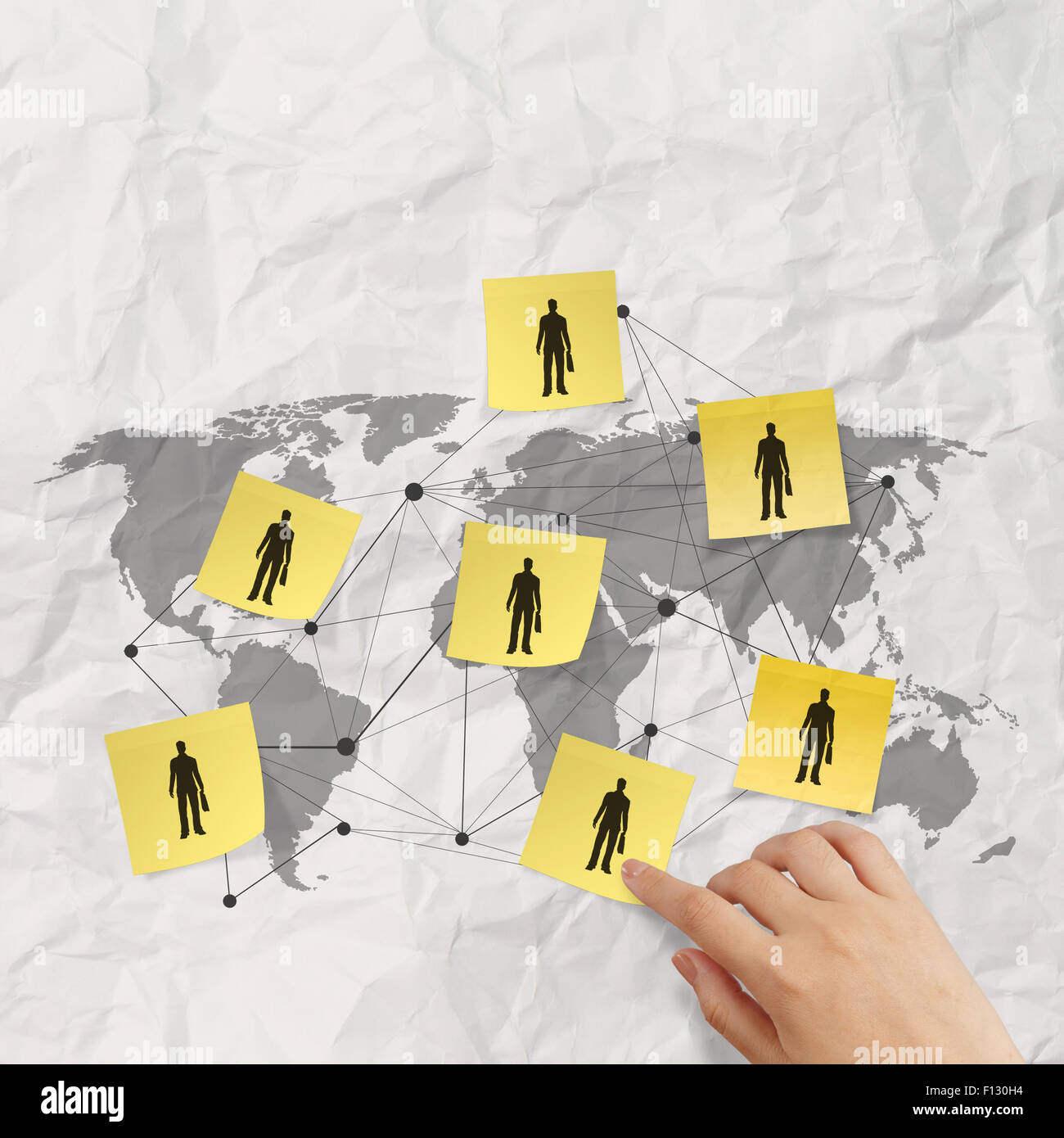 hand pushing sticky note social network icon on crumpled paper ...