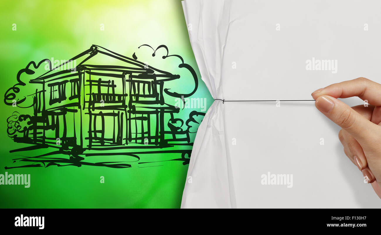 hand open crumpled paper to show skecth of house green nature ...