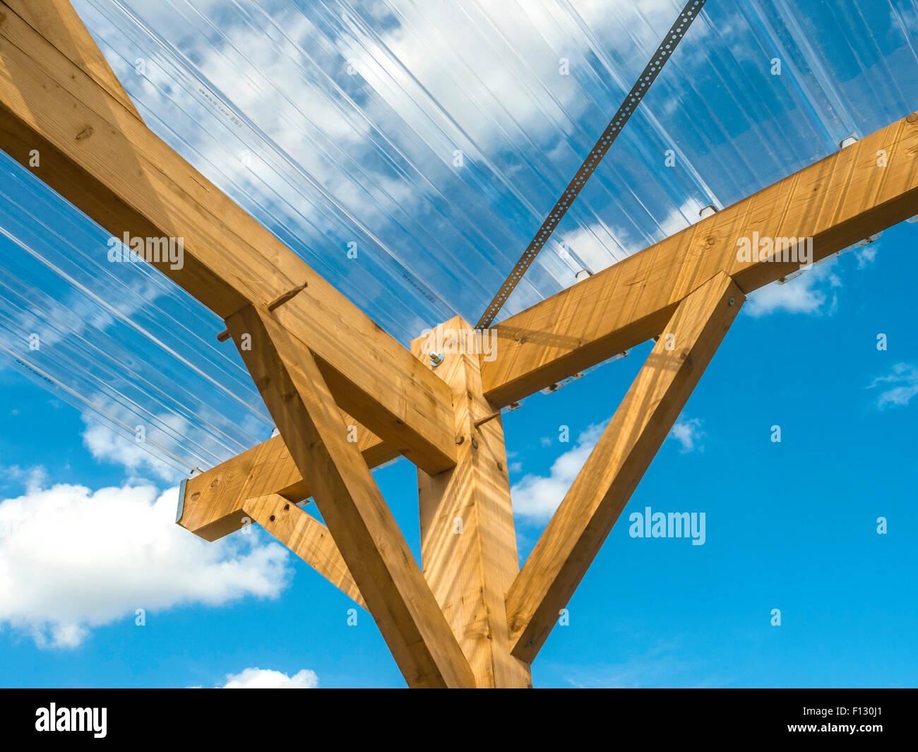 Outdoor timber shelter framework with corrugated plastic roofing ...