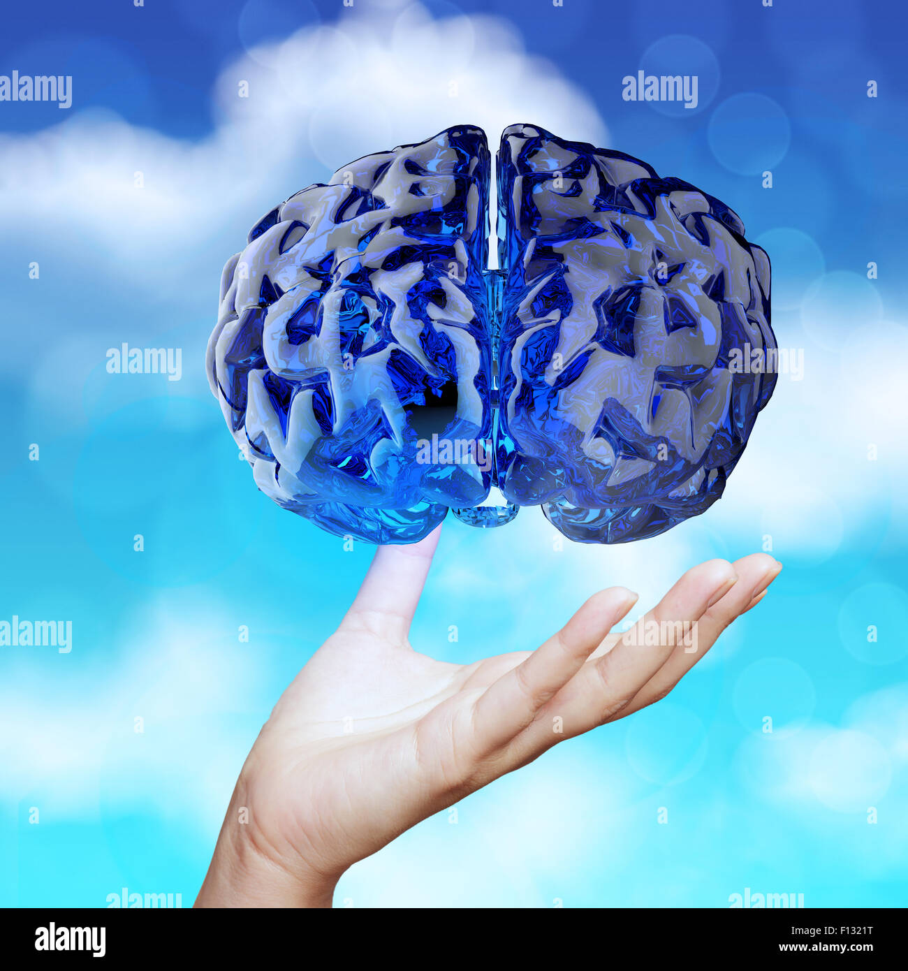 medical doctor hand showing 3d blue glass human brain on nature ...