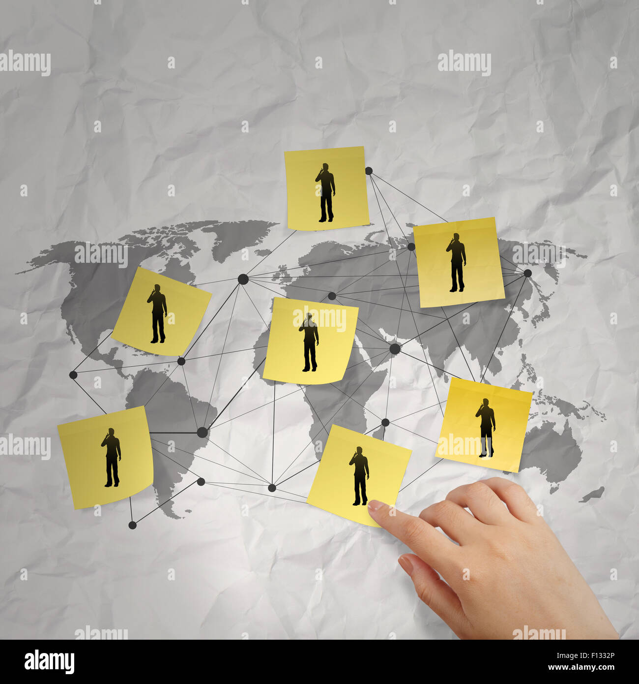 hand pushing sticky note social network icon on crumpled paper ...