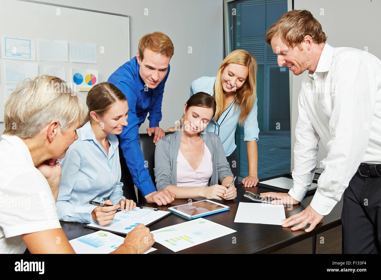 Young business people working together as a team in the office with ...