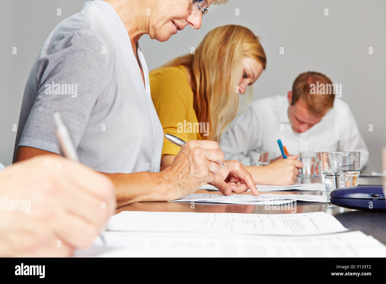 Hands of business people writing and signing contracts Stock Photo - Alamy