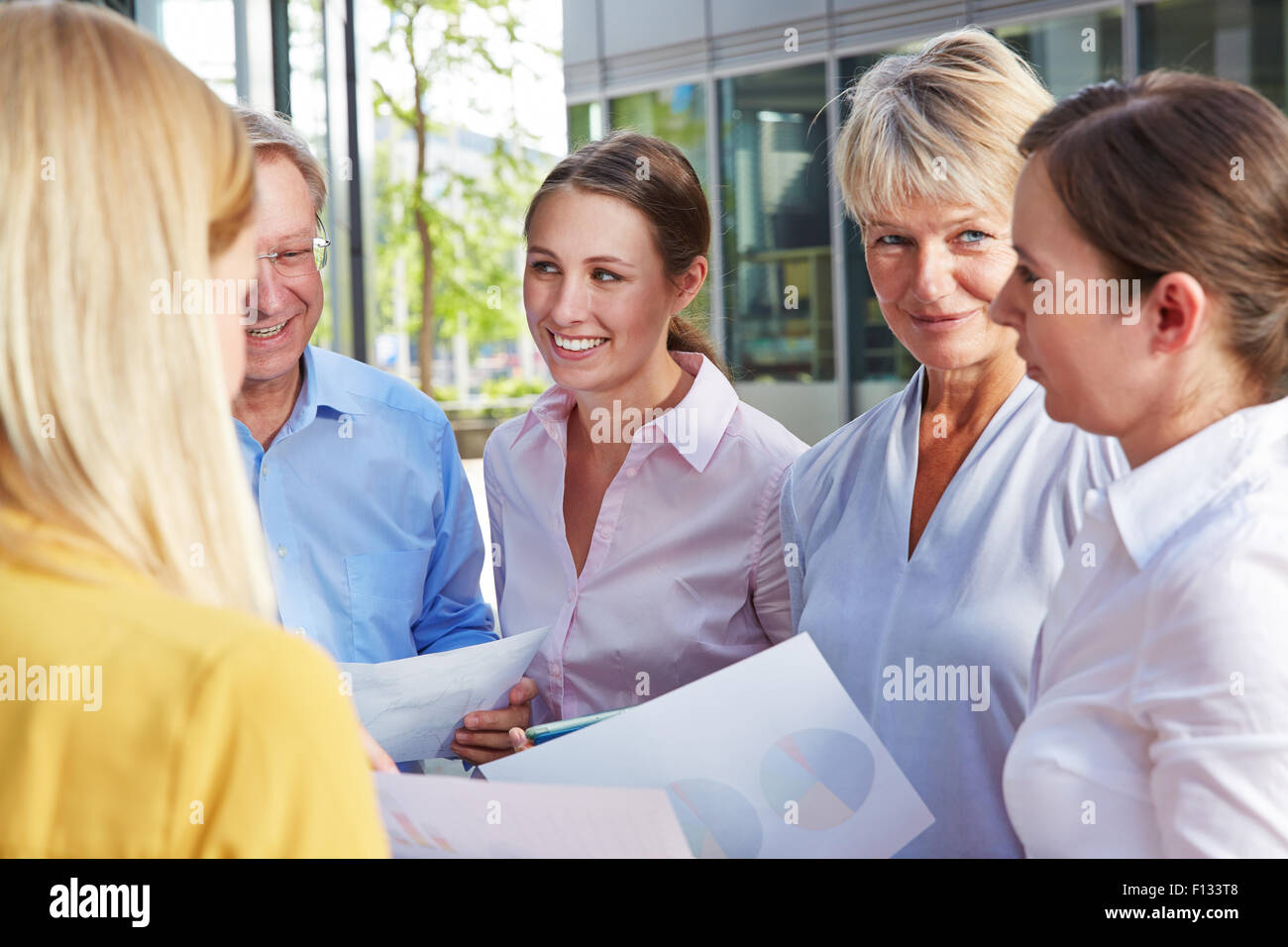 Many business people talking to each other in a team meeting Stock ...