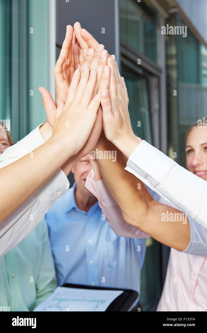 Many hands clapping high five in a business people team Stock Photo - Alamy