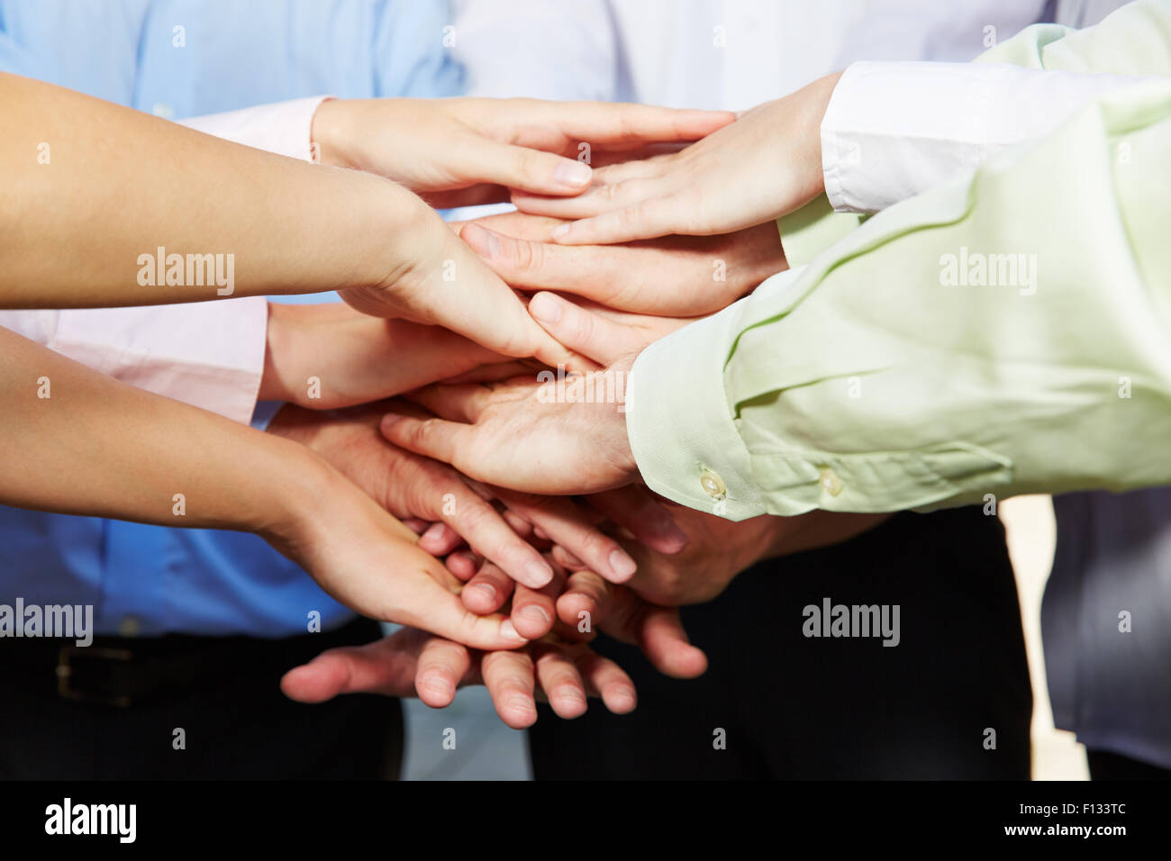 Many hands stacked hi-res stock photography and images - Alamy