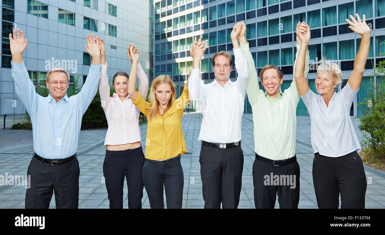 Motivated business people team raising arms up together Stock Photo - Alamy