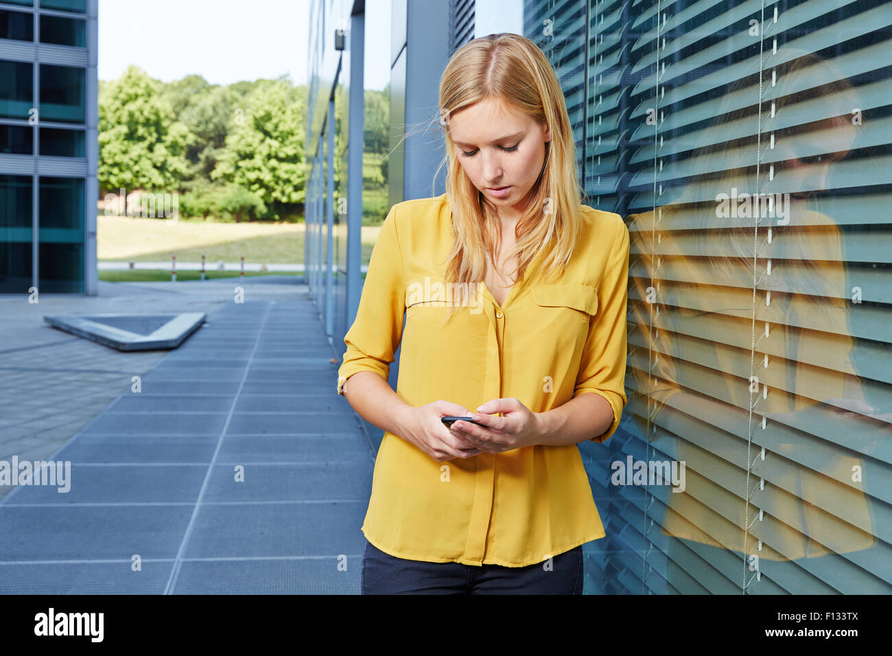 Female student reading a chat message on her smartphone display Stock ...