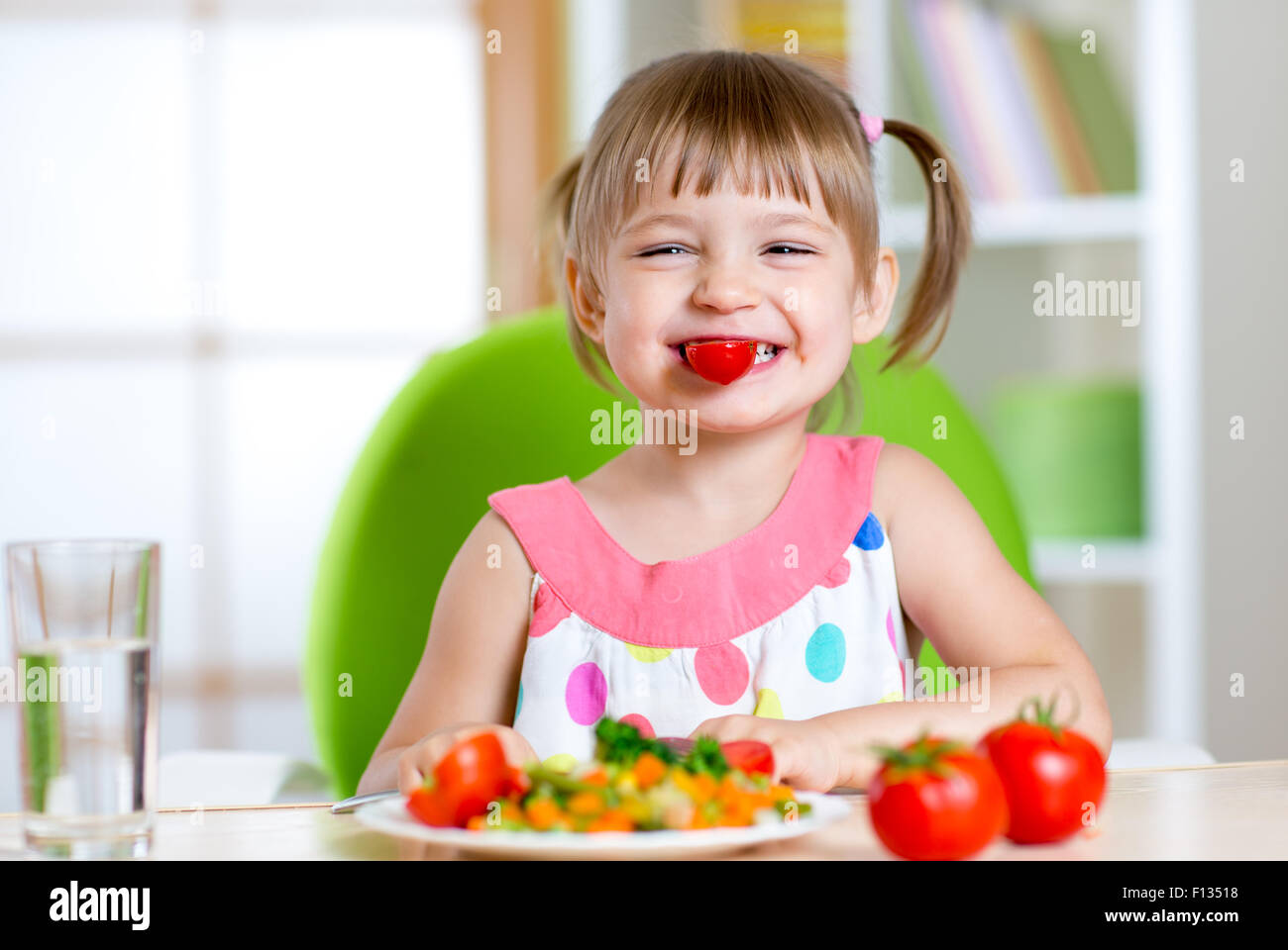 kid girl eating healthy vegetables Stock Photo - Alamy