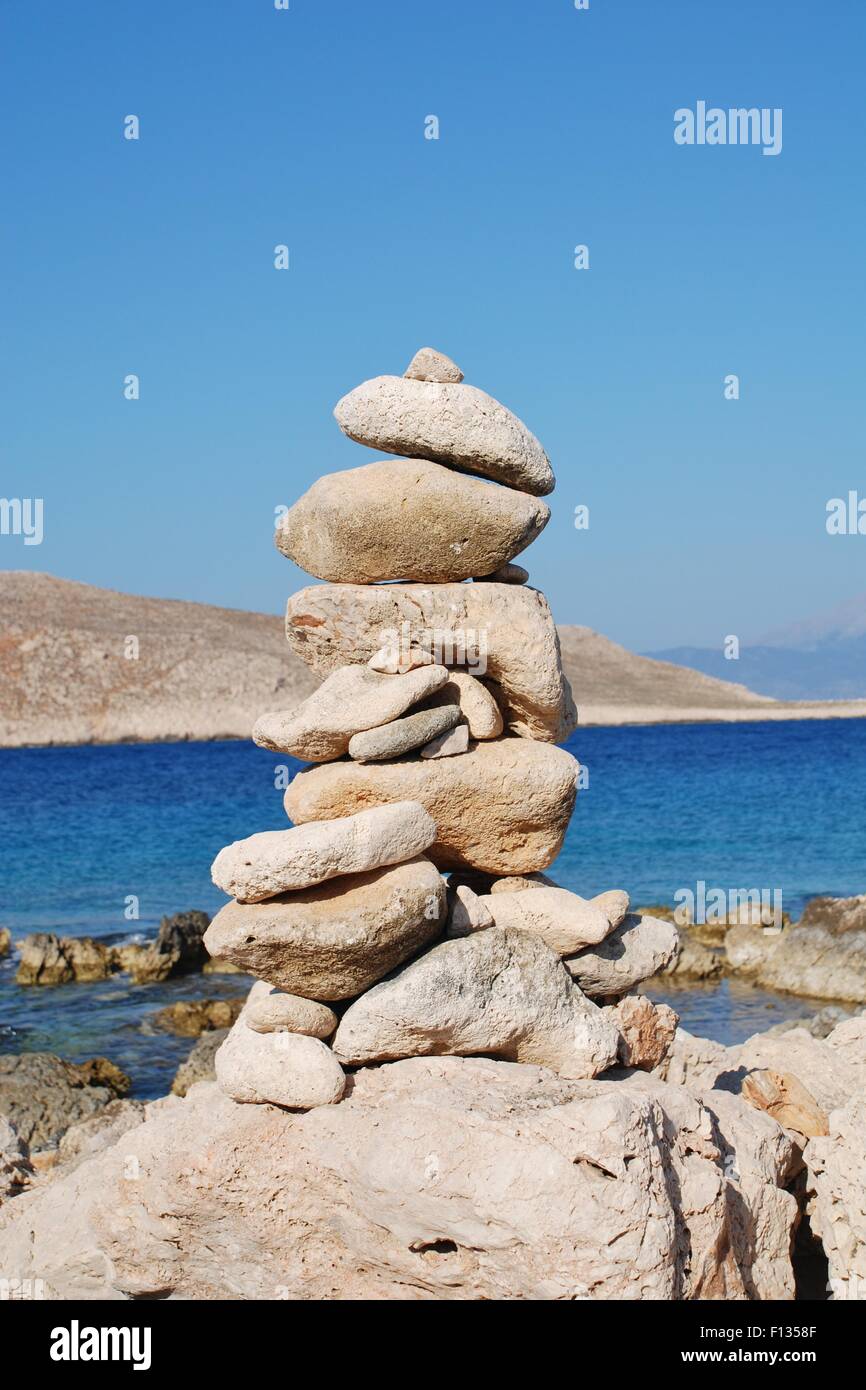 A pile of stones on Ftenegia beach at Emborio on the Greek island of ...