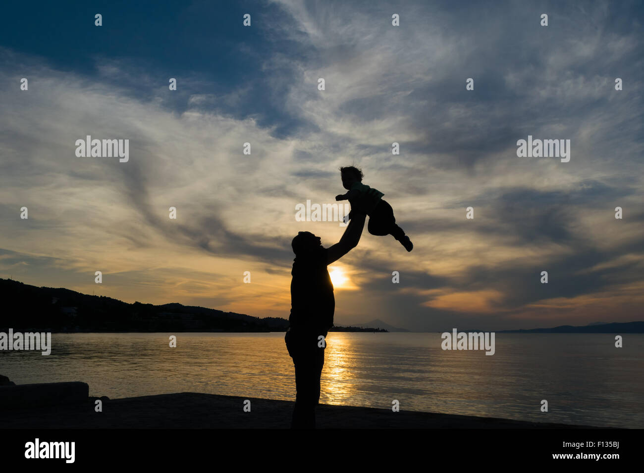 Family loving moment with father and son against dramatic sky Stock ...