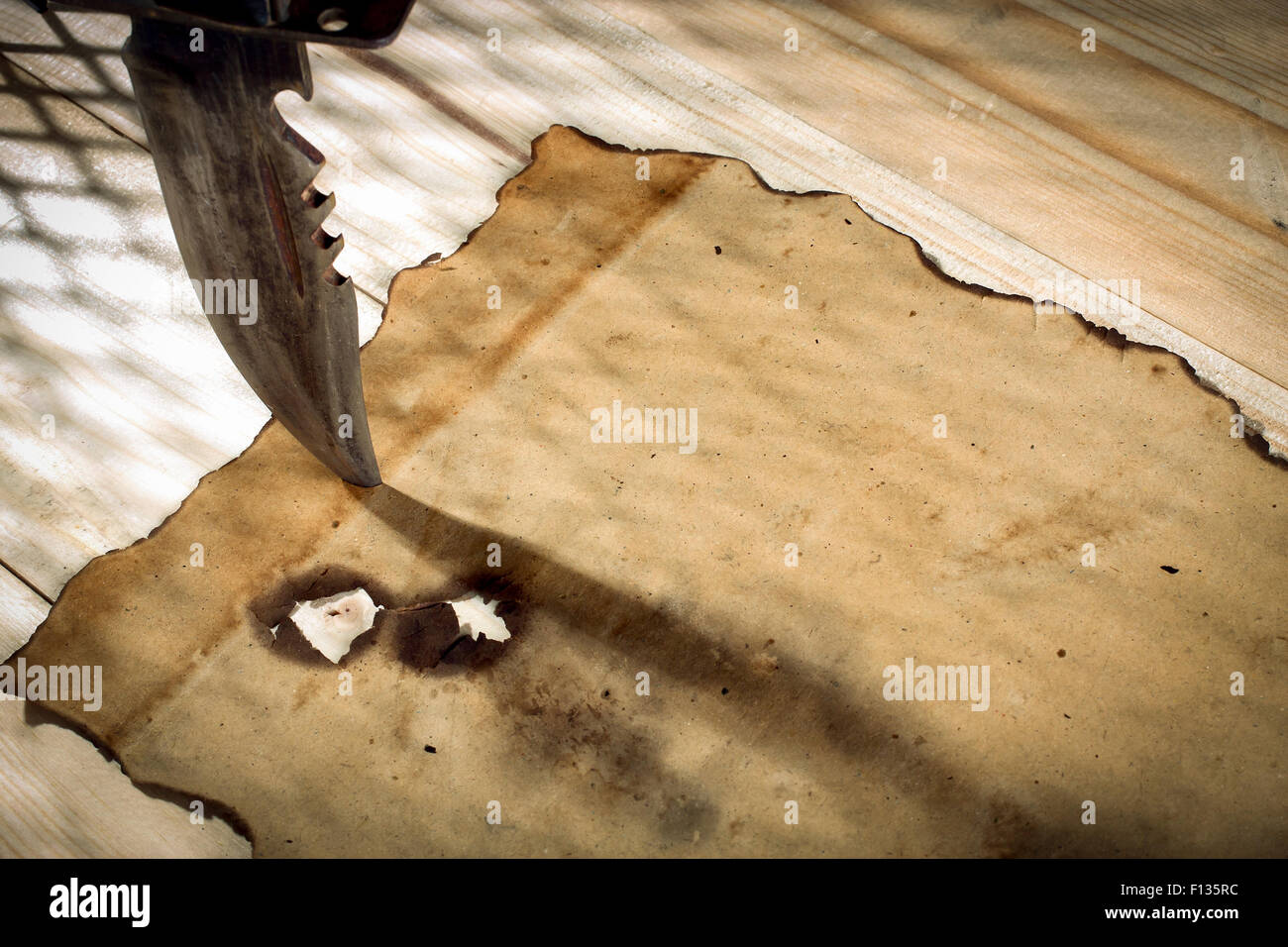 Combat knife stick on a wooden table with old paper Stock Photo - Alamy