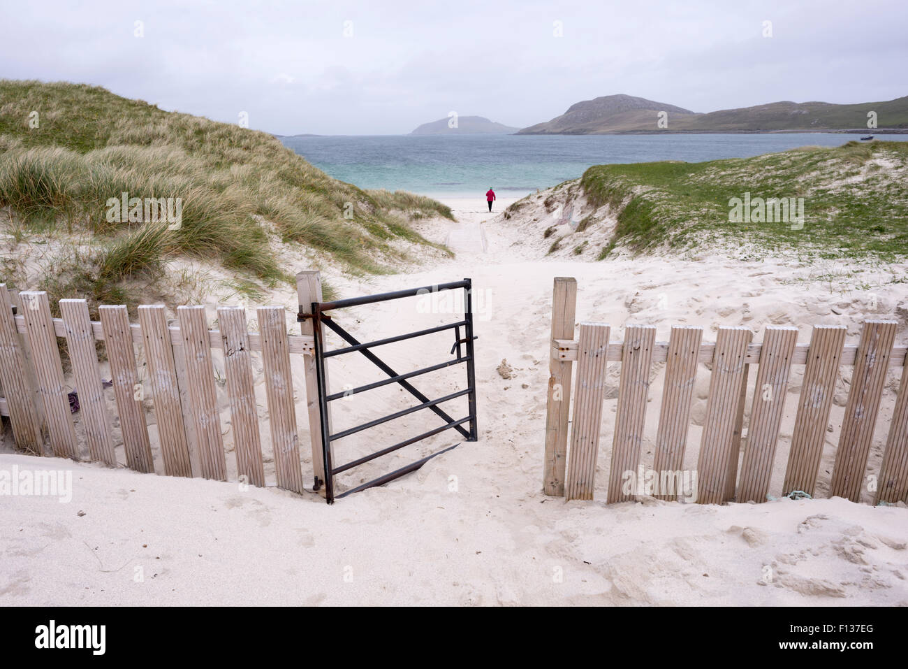 Sand dunes and beach with fence and gate on the isle of Barra, Outer ...