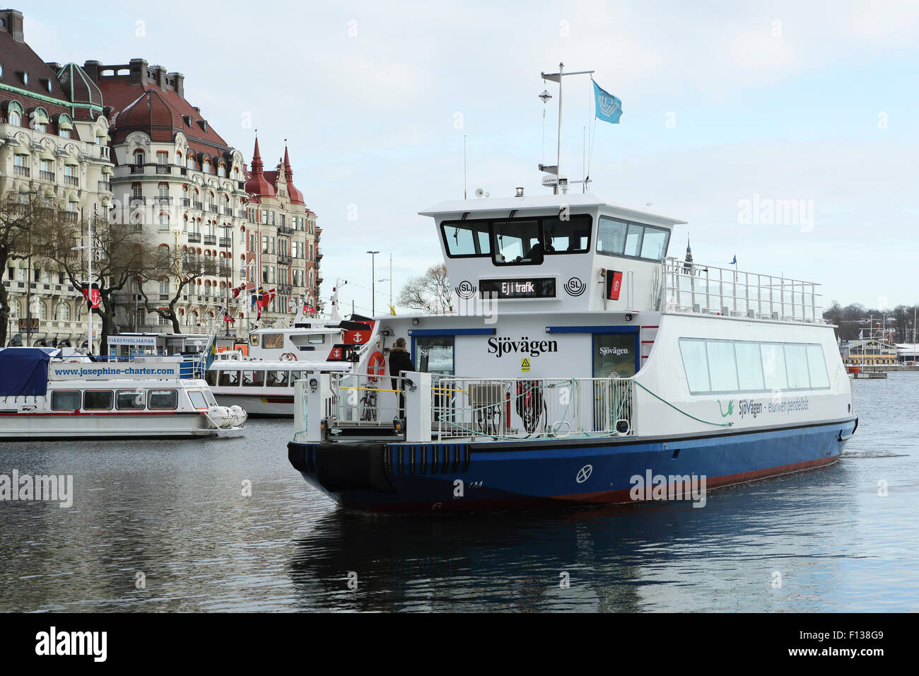 A ferry docks at Nybroviken in Stockholm, Sweden. The waterfront area ...
