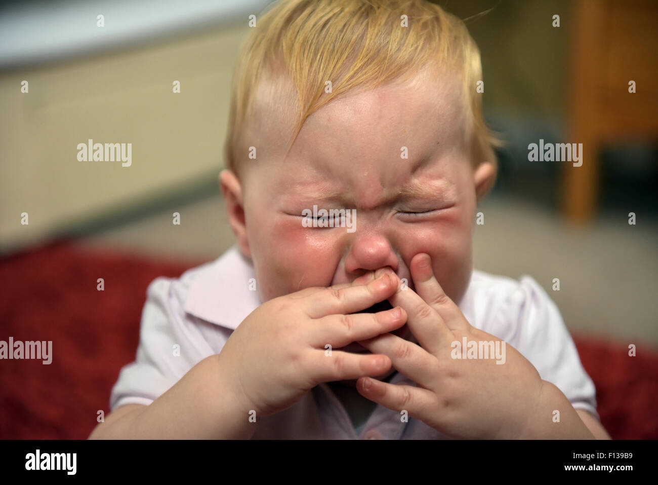 A distressed eleven month old baby with a temperature crying Stock ...