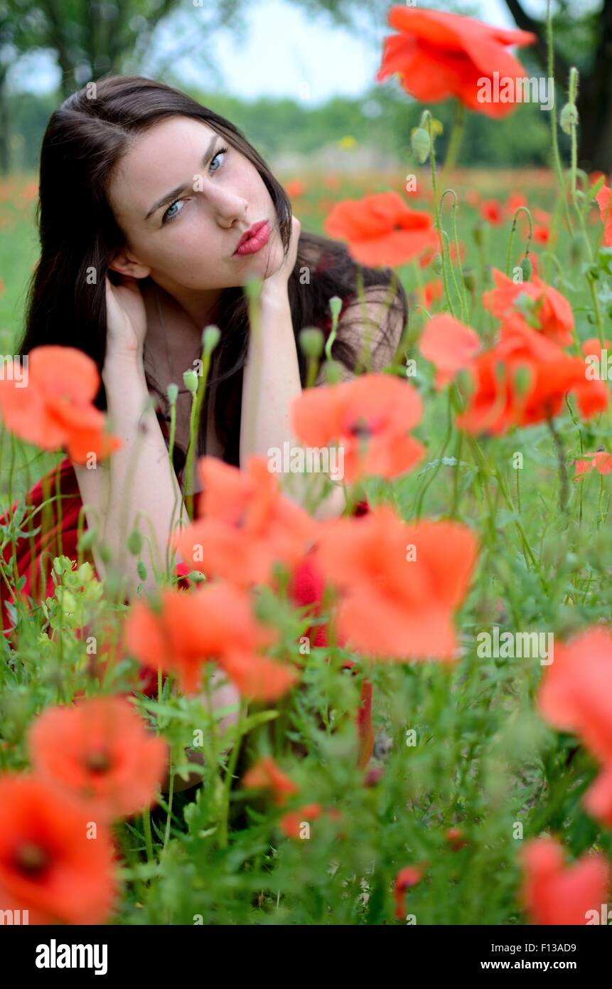 Young Female Model Posing Surrounded By Poppies Flowers Brunette Girl