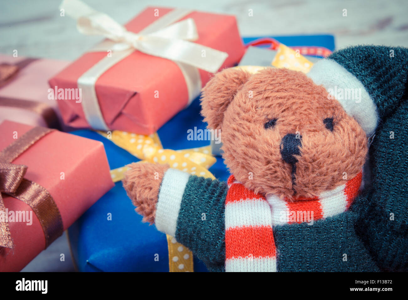 Vintage photo, Fluffy teddy bear and heap of wrapped colorful gifts for ...