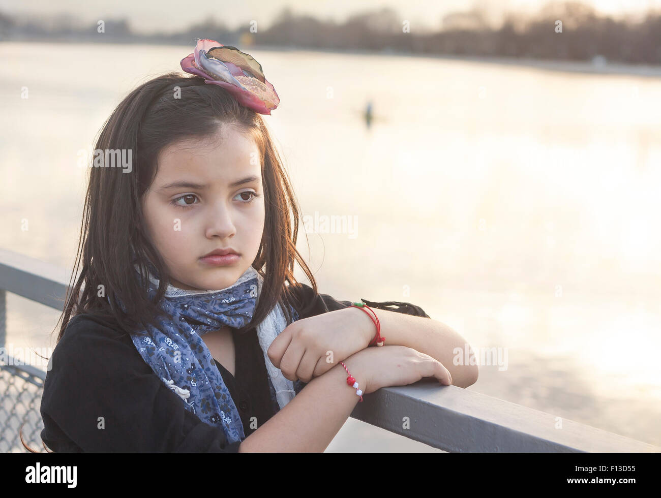 Portrait of a girl standing by a river Stock Photo - Alamy