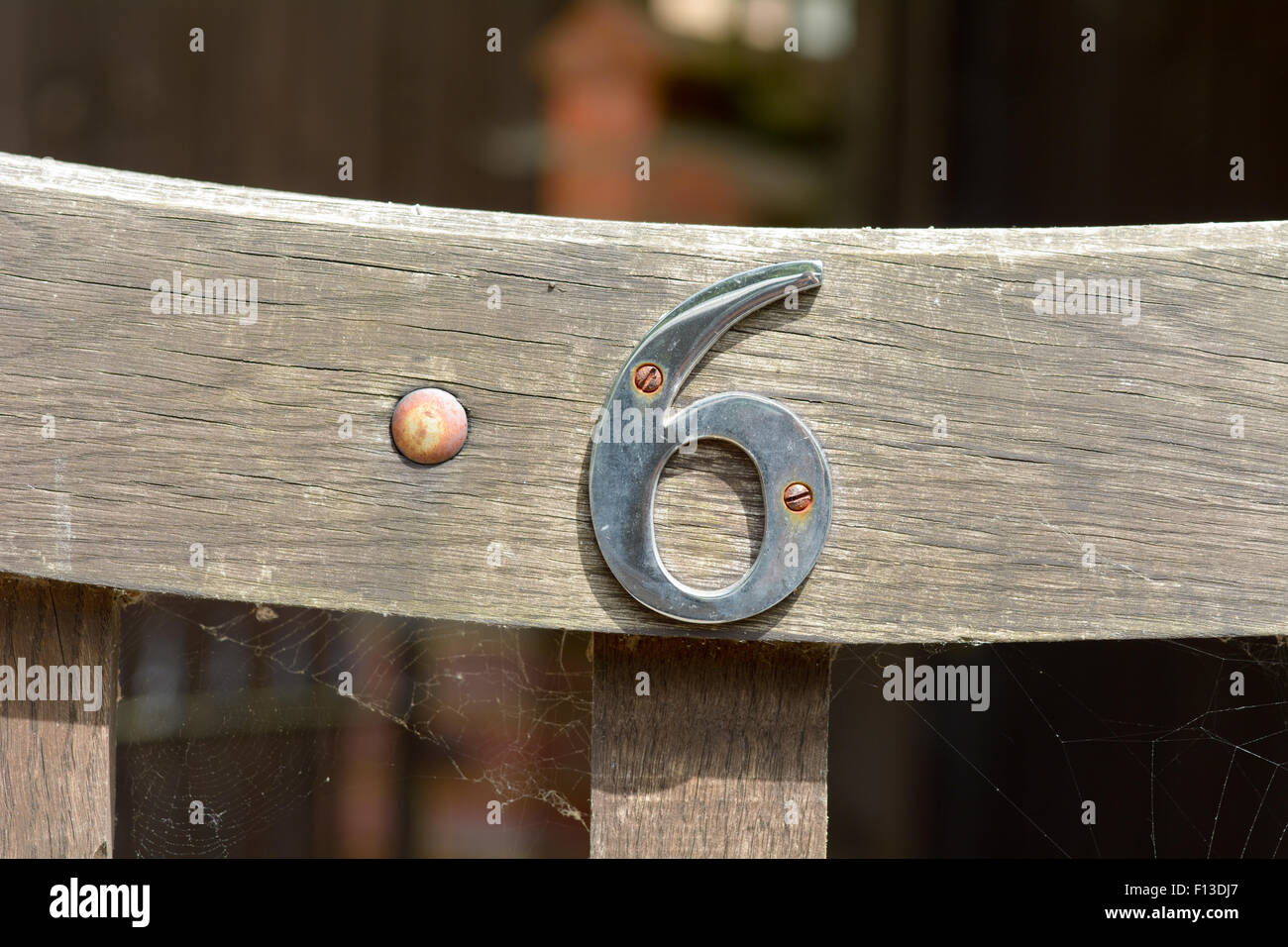 Number 6 sign on wooden gate at entrance to property Stock Photo - Alamy