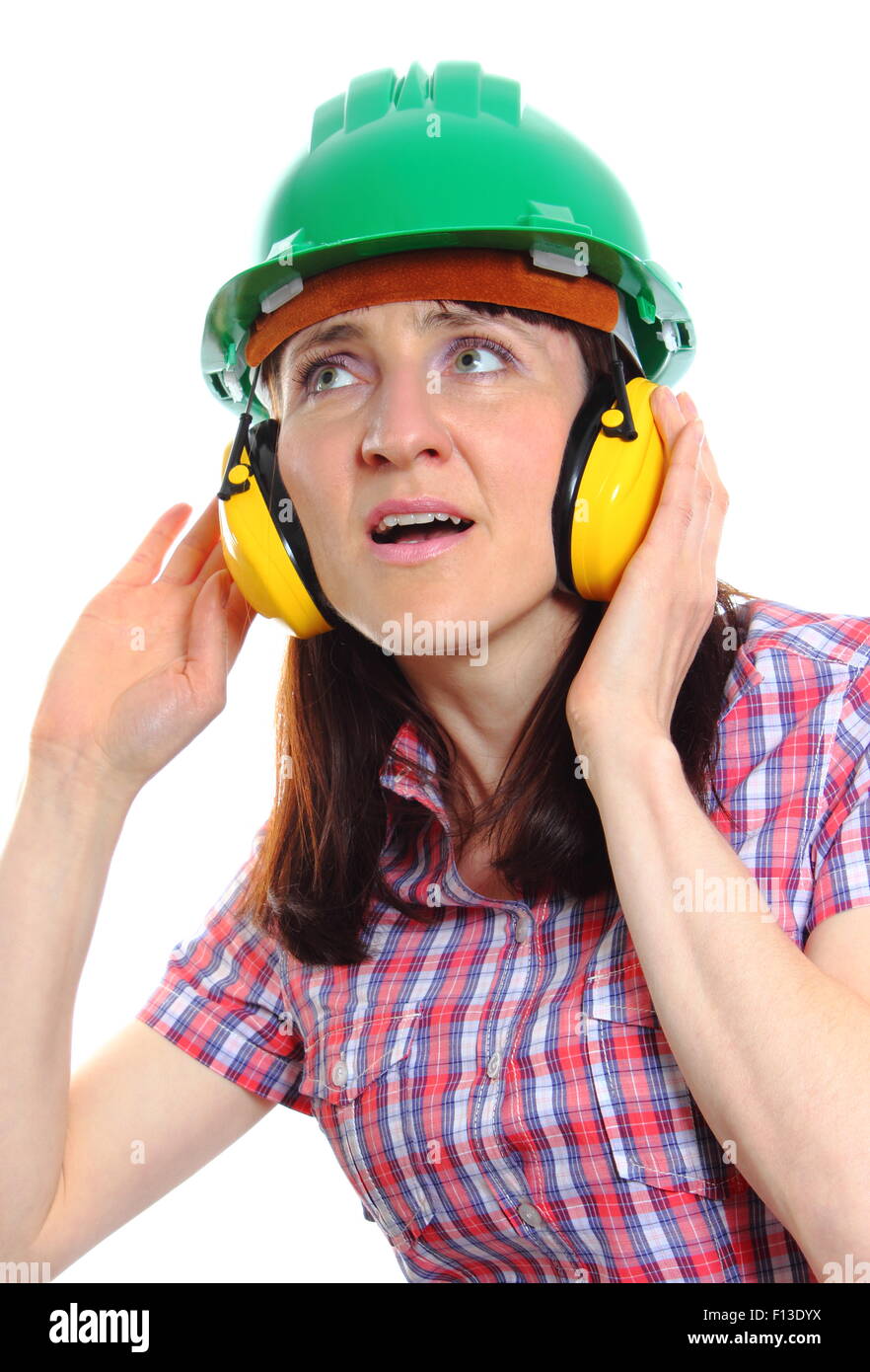 Female construction worker can not hear because wearing green helmet and protective headphones ...