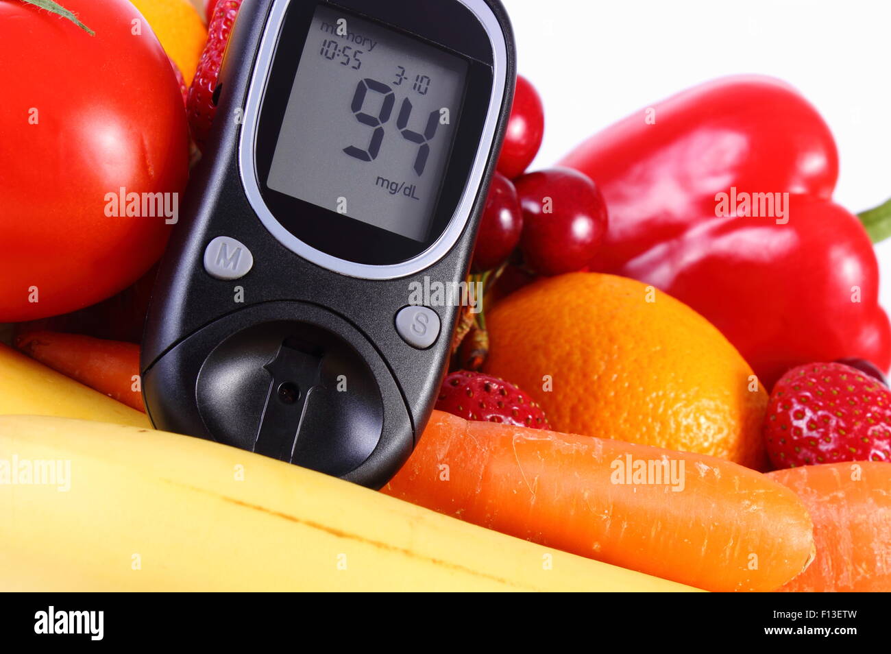 Glucose meter with fresh ripe fruits and vegetables, concept of ...