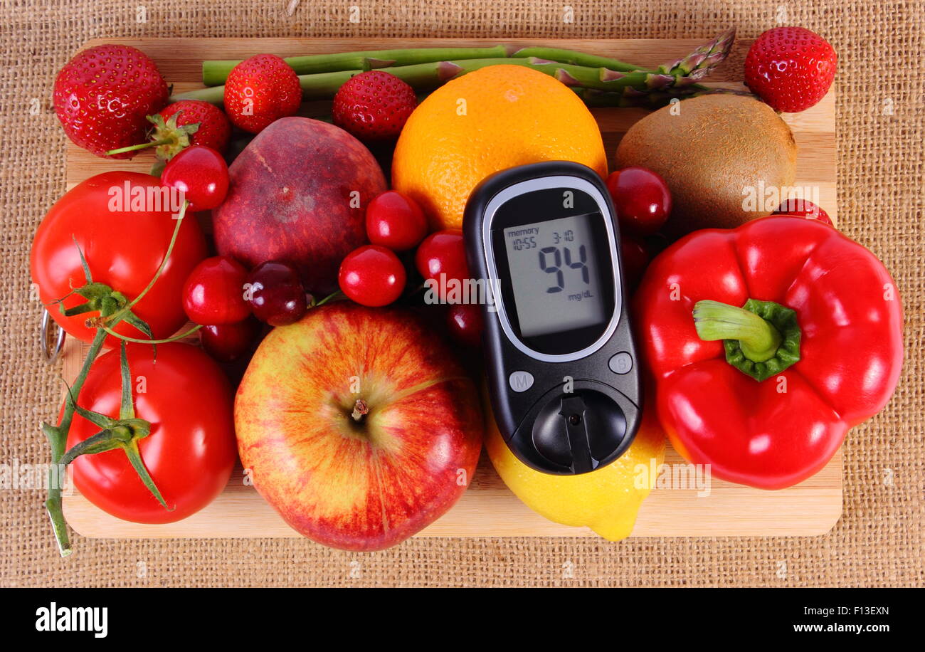 Glucose meter with fresh ripe fruits and vegetables, concept of ...