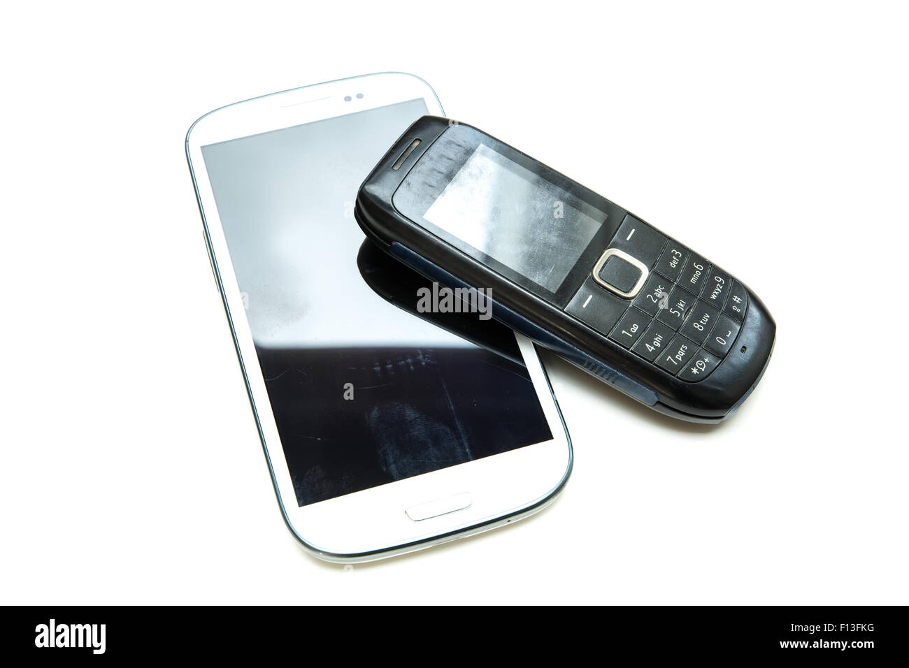 A modern smartphone and a old classic cell phone side by side Stock ...