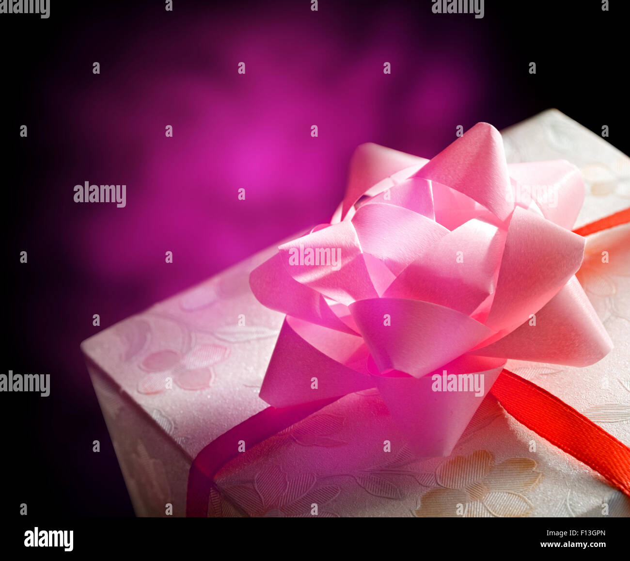 Gift box with a pink bow and ribbon Stock Photo - Alamy