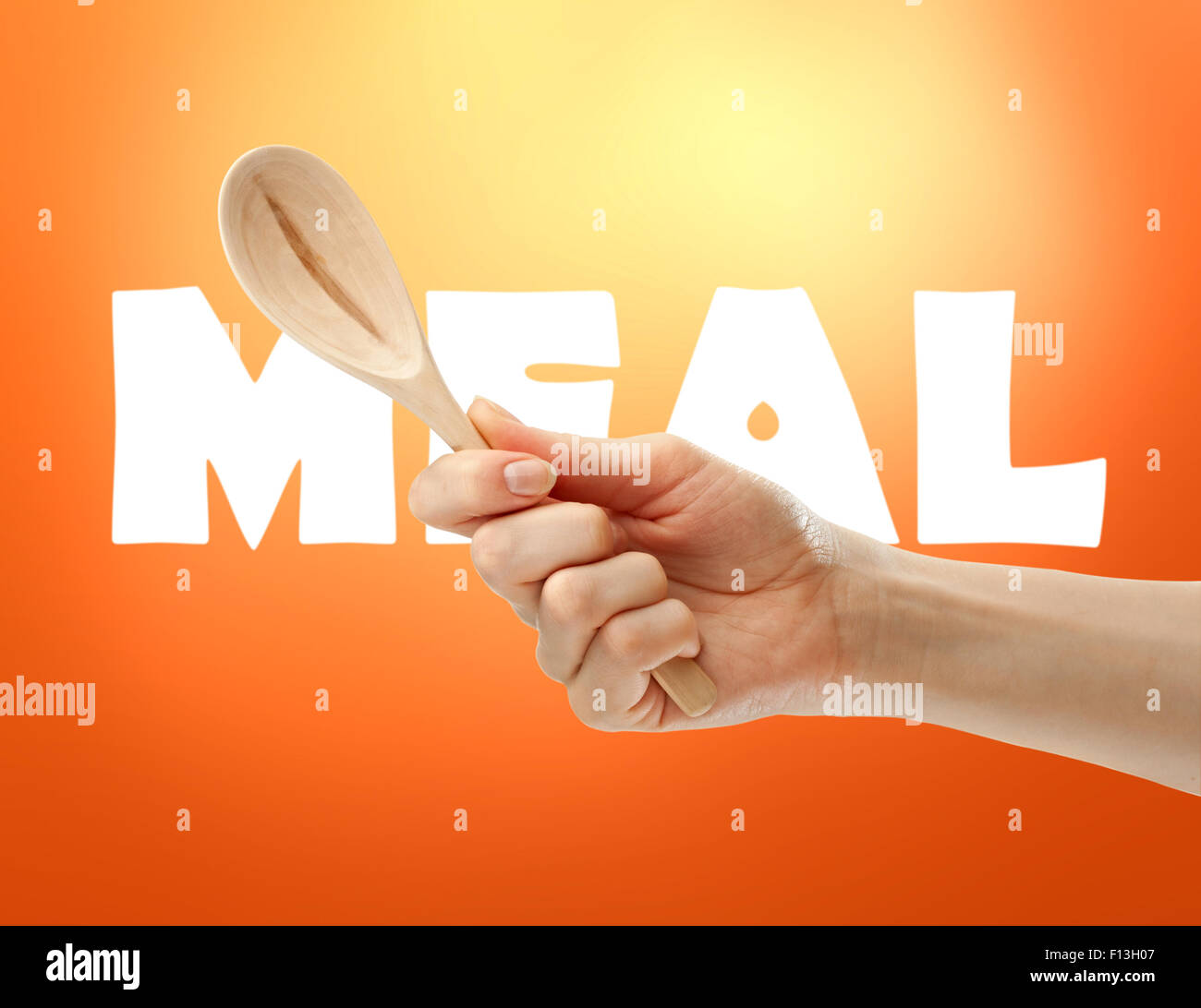 Wooden spoon in female hand in closeup Stock Photo - Alamy