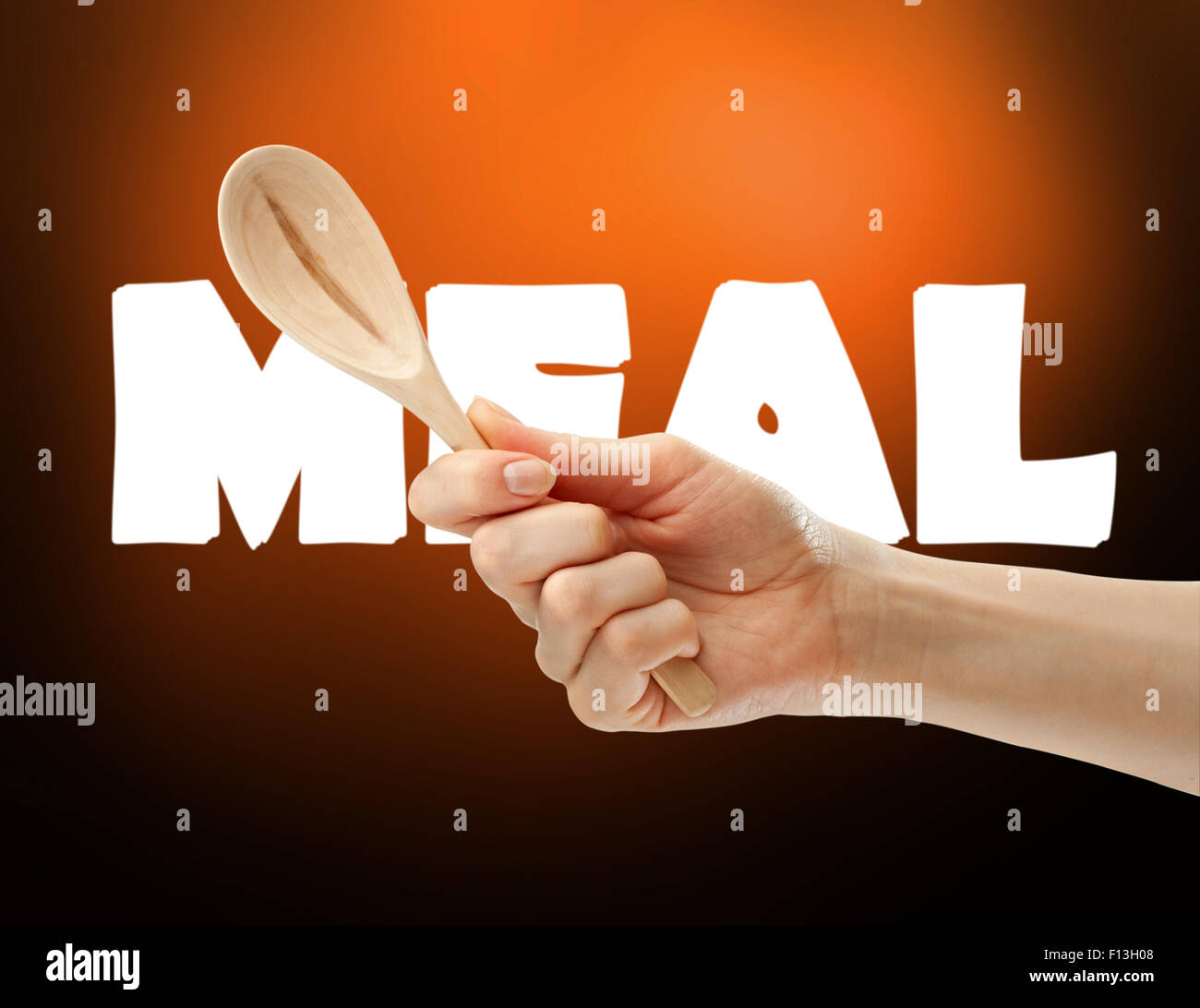 Wooden spoon in female hand in closeup Stock Photo - Alamy