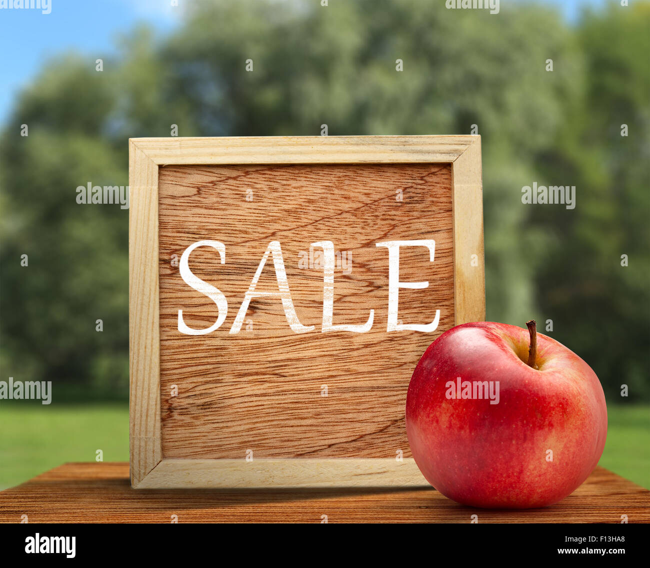 Red apple with wooden frame on nature background Stock Photo - Alamy