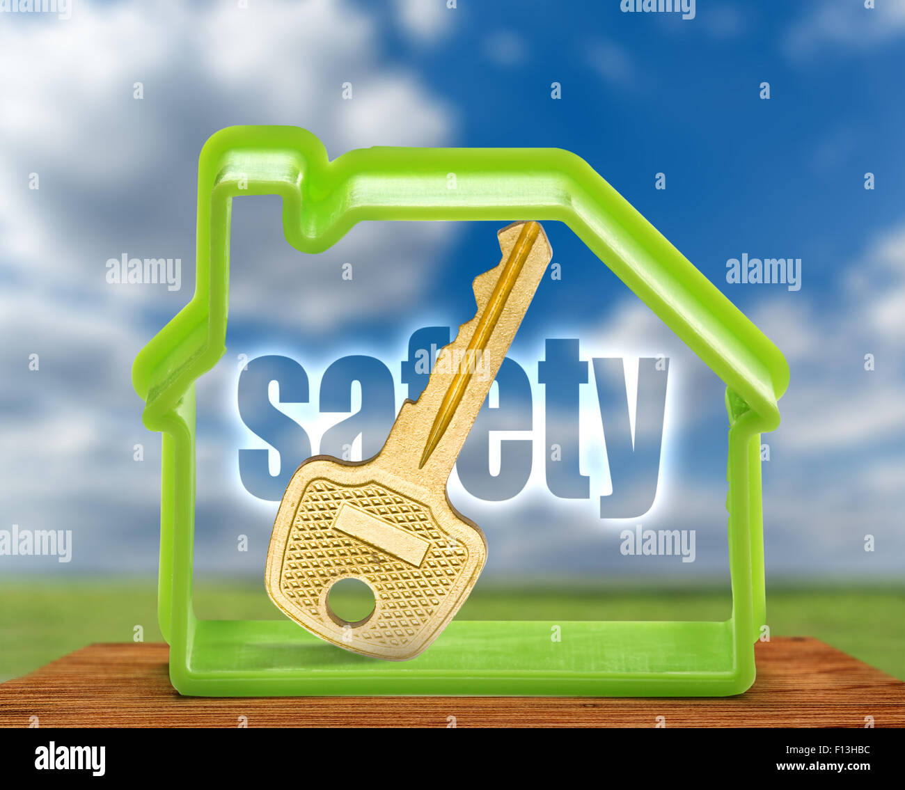 Toy house form with key as symbol outdoors Stock Photo - Alamy
