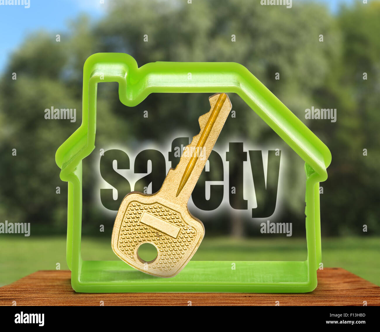 Toy house form with key as symbol outdoors Stock Photo - Alamy