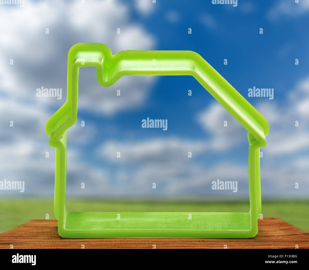 Toy house form as symbol on outdoors background Stock Photo - Alamy