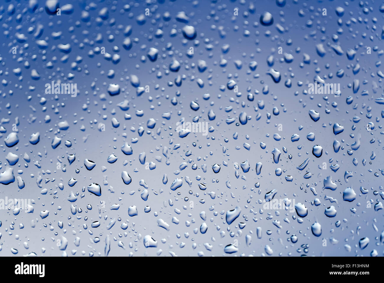 Cold rain drops on window as background Stock Photo - Alamy