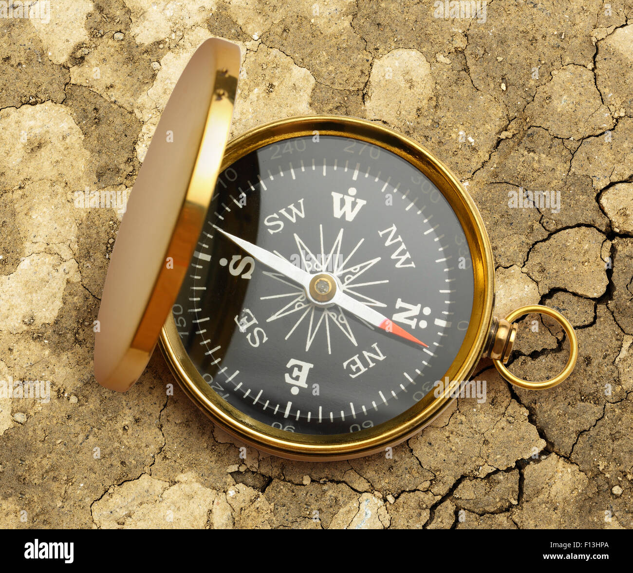 Golden vintage compass opened on soil background Stock Photo - Alamy