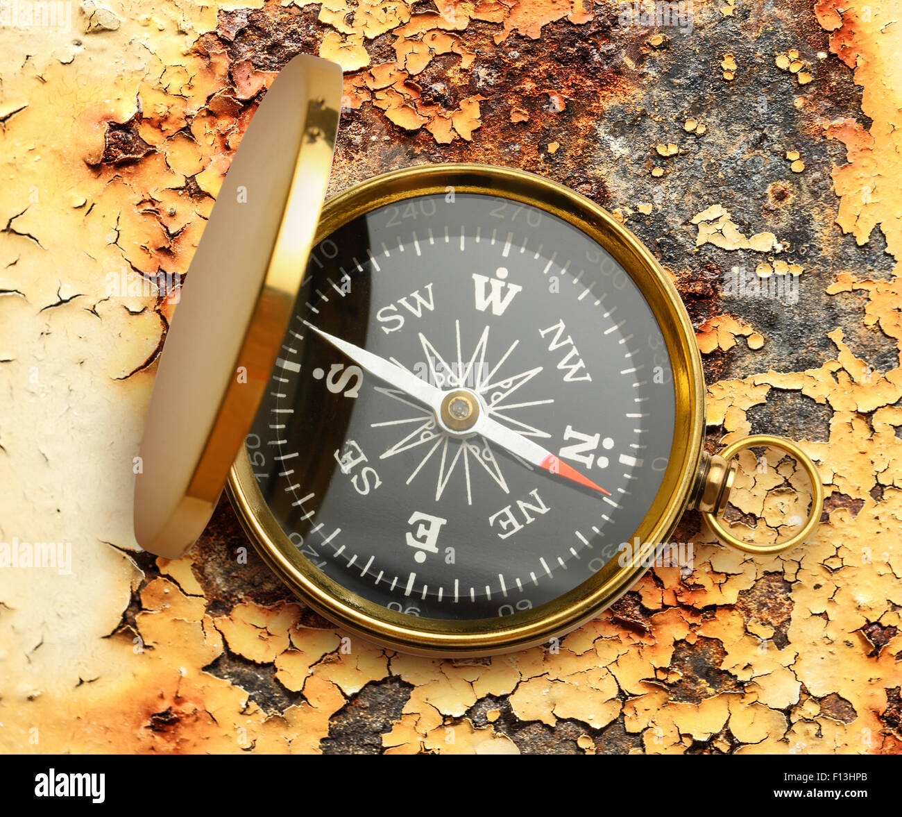 Golden vintage compass opened on rusty background Stock Photo - Alamy