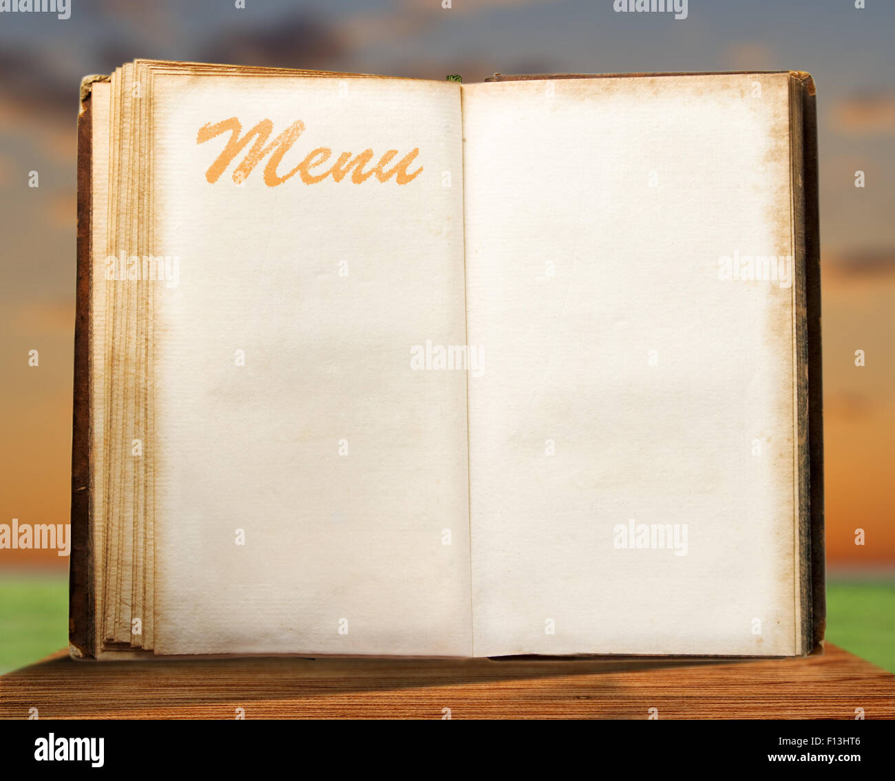 Open blank vintage menu book on sky background Stock Photo - Alamy